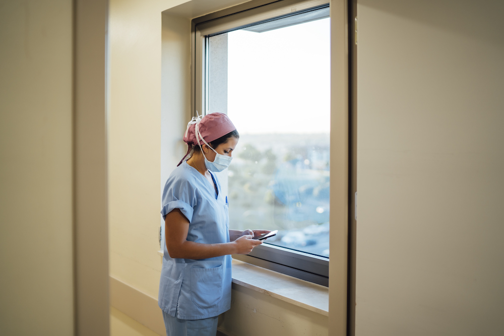 Female doctor surgeon using smart phone. regional and remote queensland